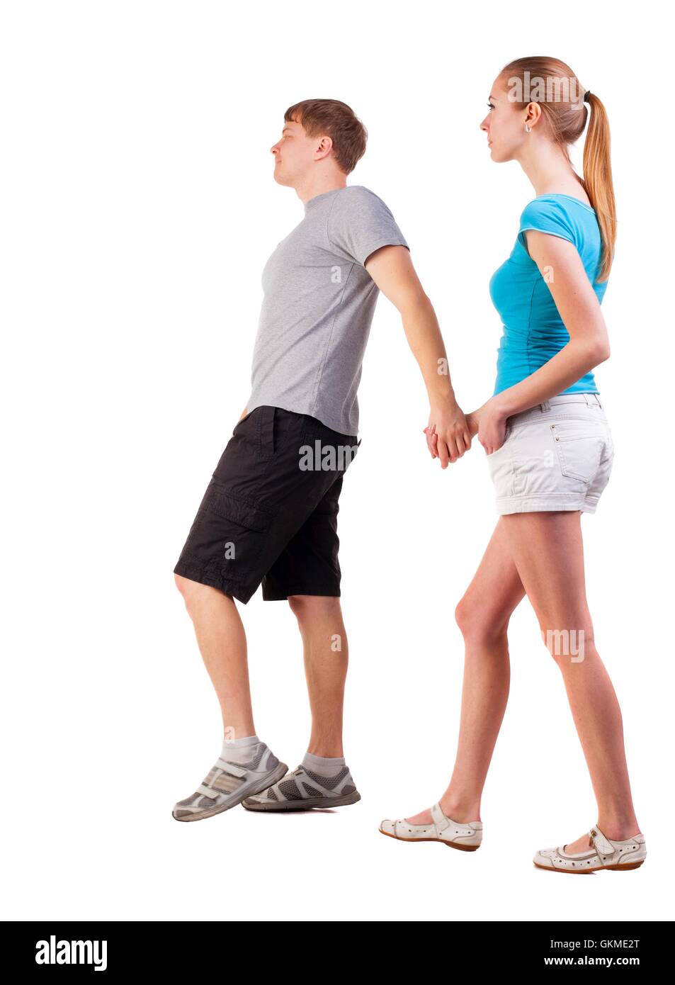 Back view of going young couple Stock Photo - Alamy