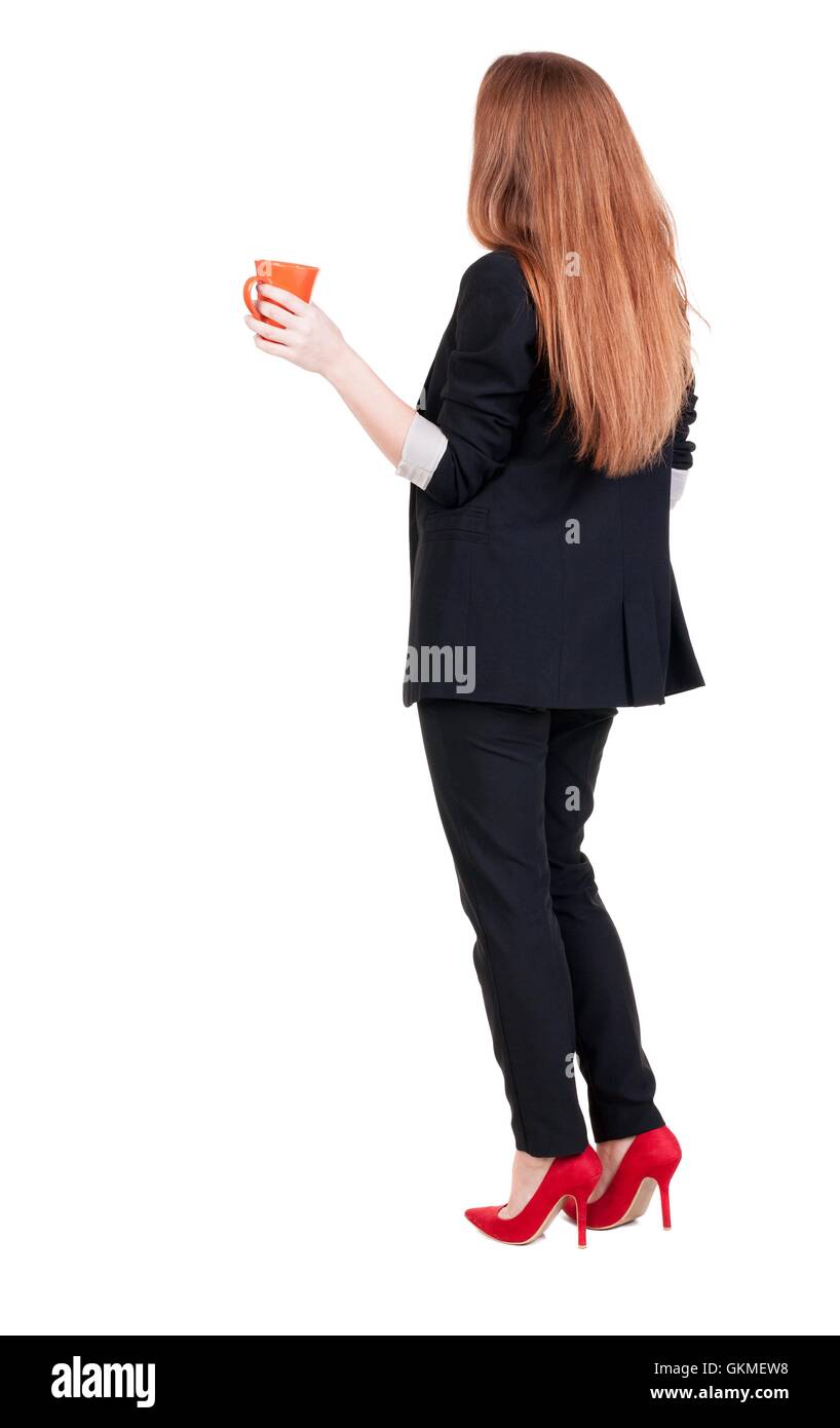 Rear view of a young business woman drinking coffee or tea while Stock ...