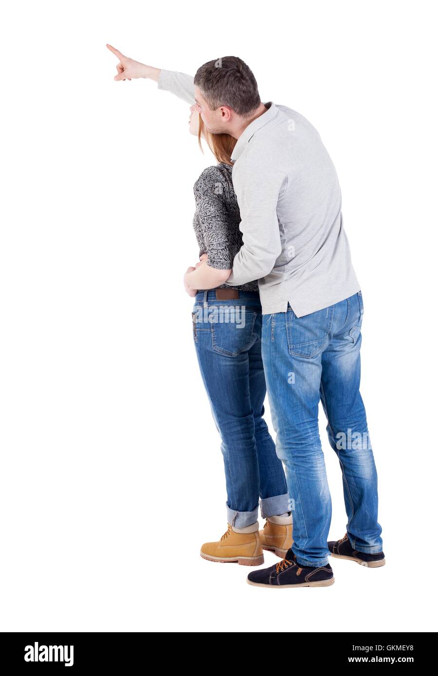 young couple pointing at wal Back view (woman and man Stock Photo - Alamy