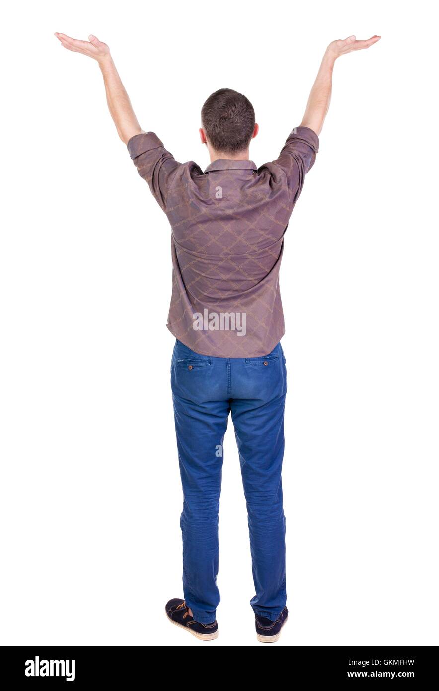 Back view of Beautiful man in jeans looking at wall and Holds h Stock ...