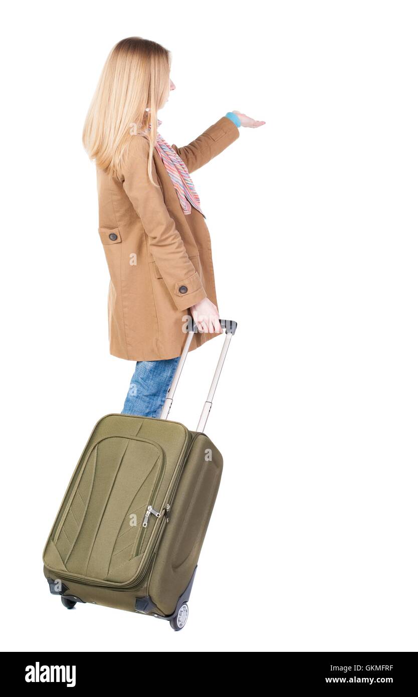 Back view of pointing woman with suitcase looking up Stock Photo - Alamy
