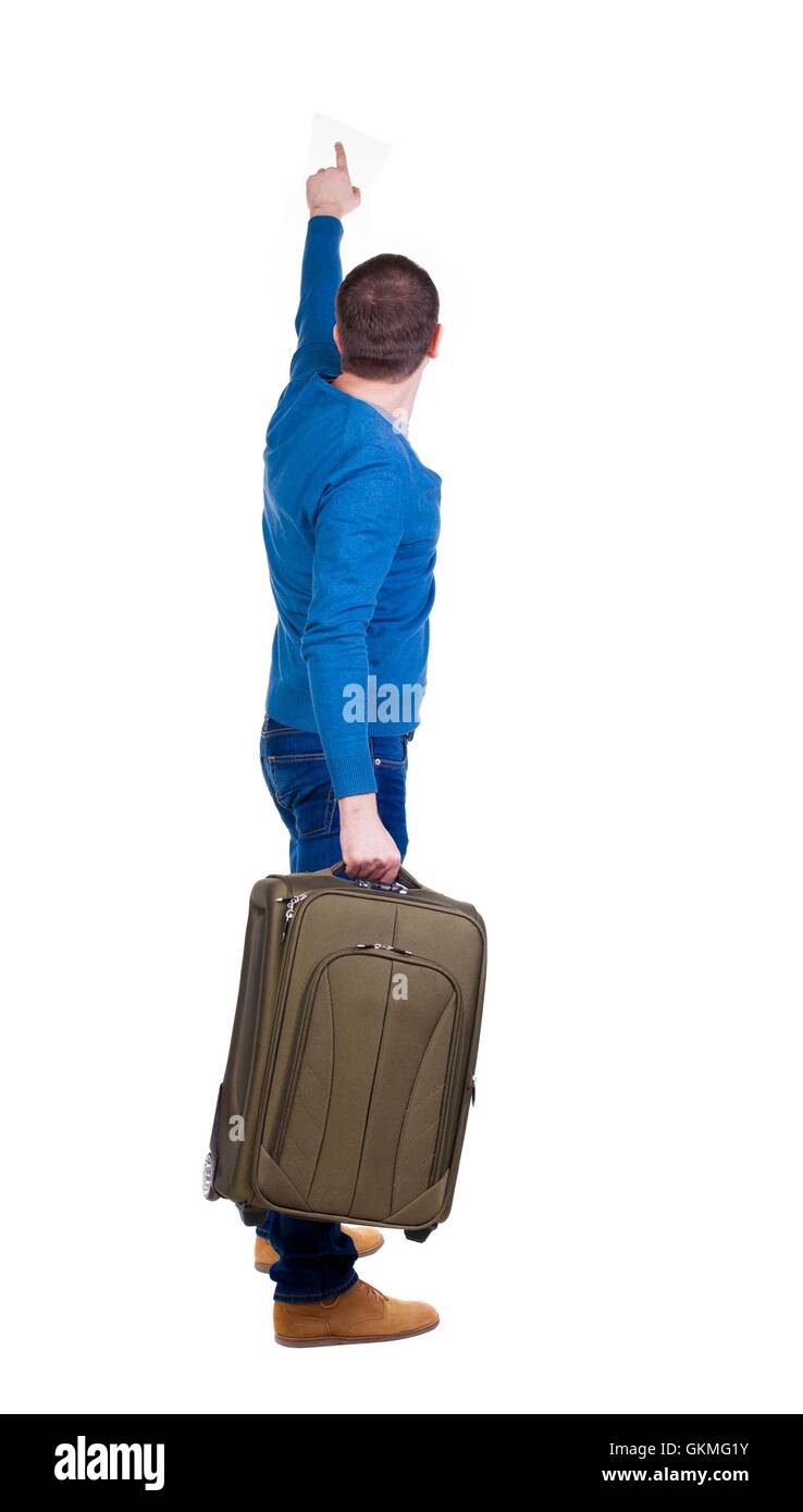 back view of pointing man with suitcase Stock Photo - Alamy