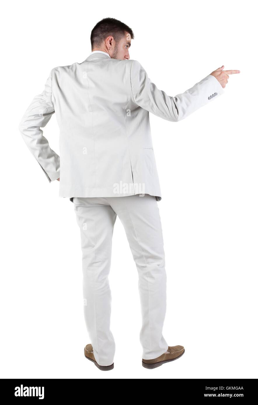 Serious young man standing wall pointing finger hi-res stock ...