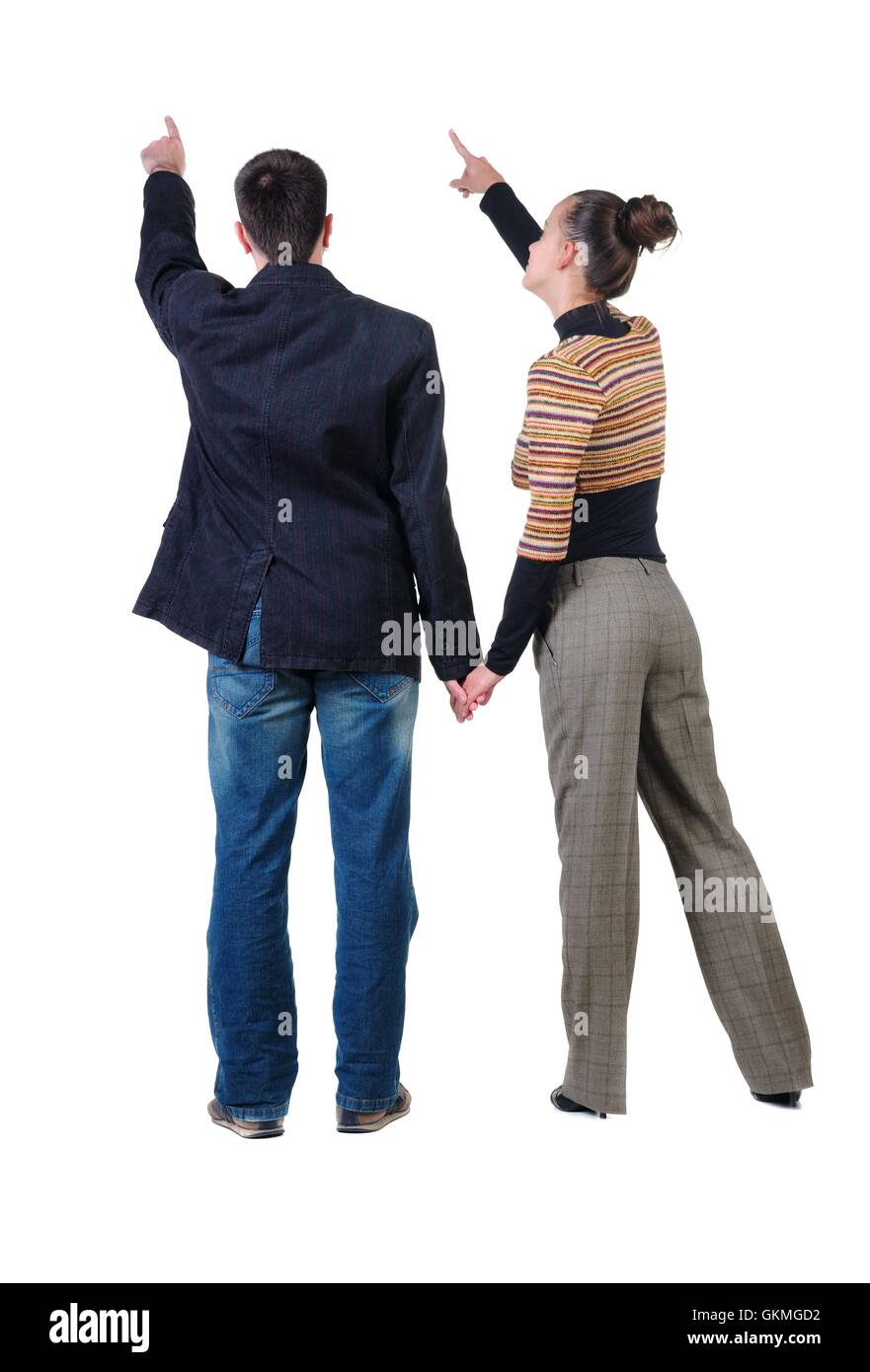 Young couple pointing at wall. Rear view Stock Photo - Alamy