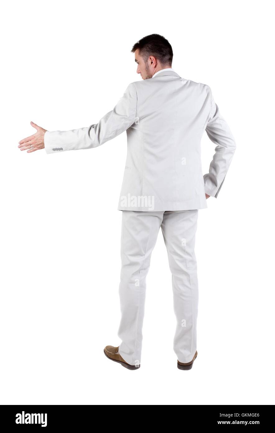 businessman extending hand to shake. Rear view Stock Photo - Alamy