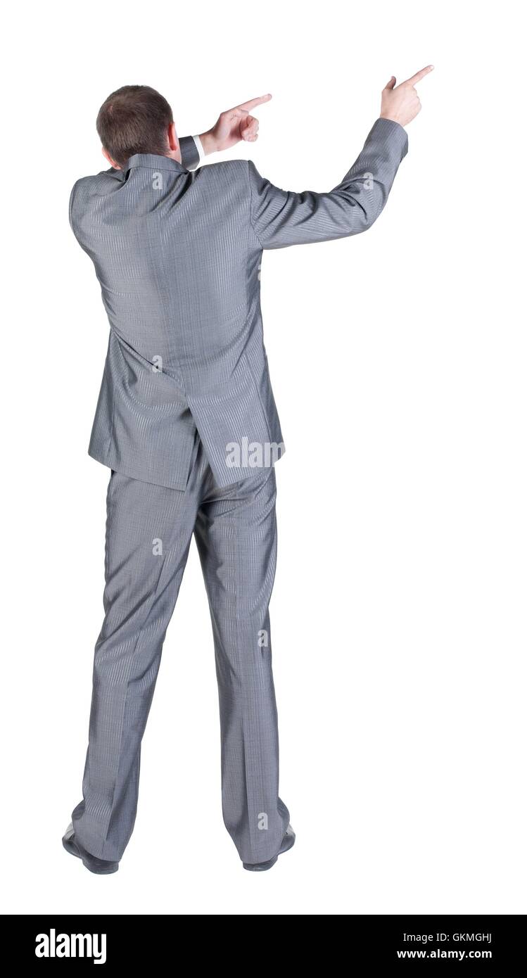 Serious young man standing wall pointing finger hi-res stock ...