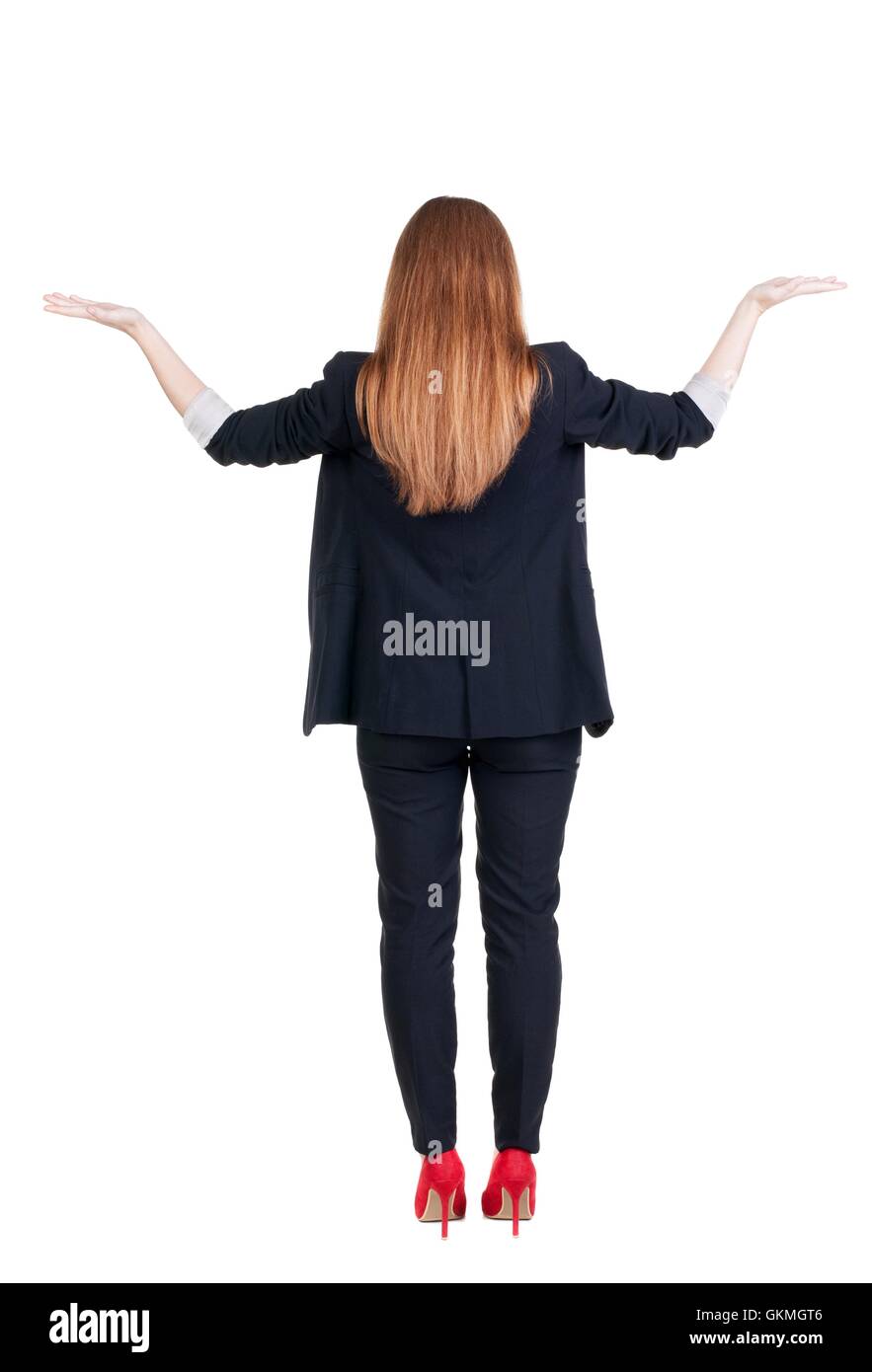 Back view of Beautiful business woman in suite looking at wall and ...