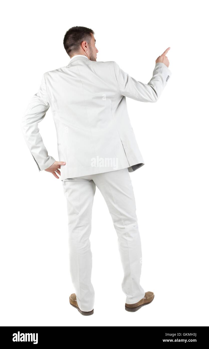 Serious young man standing wall pointing finger hi-res stock ...