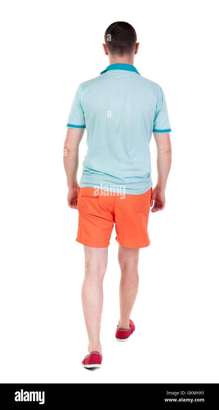Back view of going handsome man in shorts. walking young guy . Rear ...