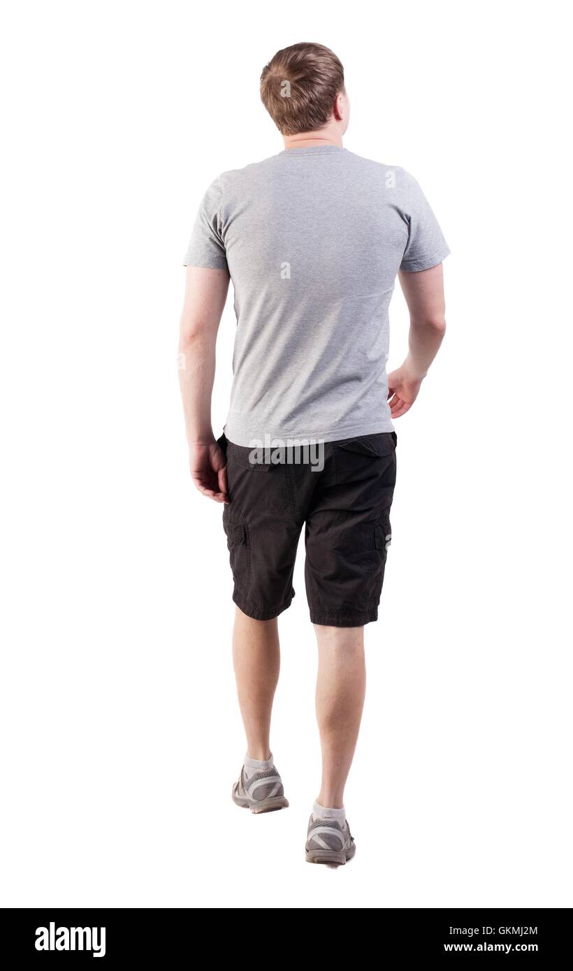 Back view of walking handsome man in shorts and sneakers Stock Photo ...