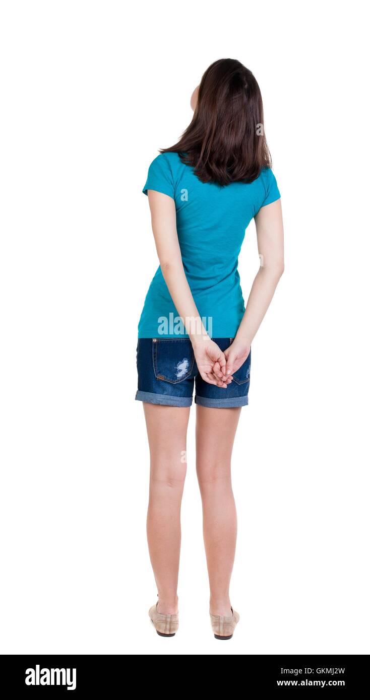 back view of standing young beautiful brunette woman in shorts. girl ...