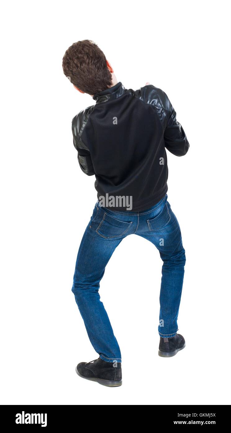 back view of standing man pulling a rope from the top or cling t Stock ...