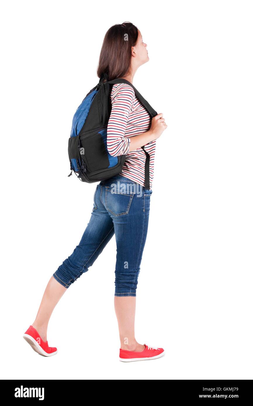 back view of standing young beautiful brunette woman with backpack ...
