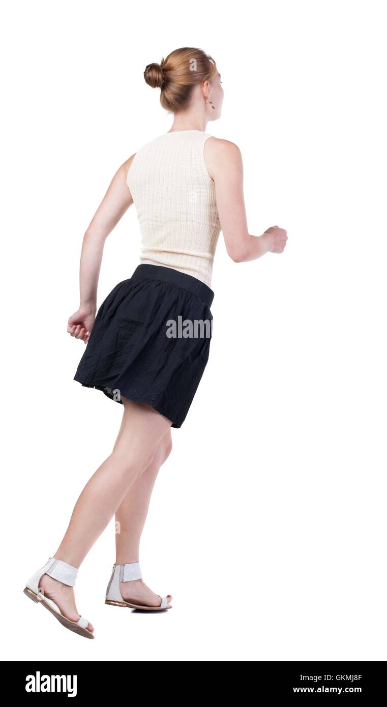 back view of running woman in dress. beautiful blonde girl in motion ...
