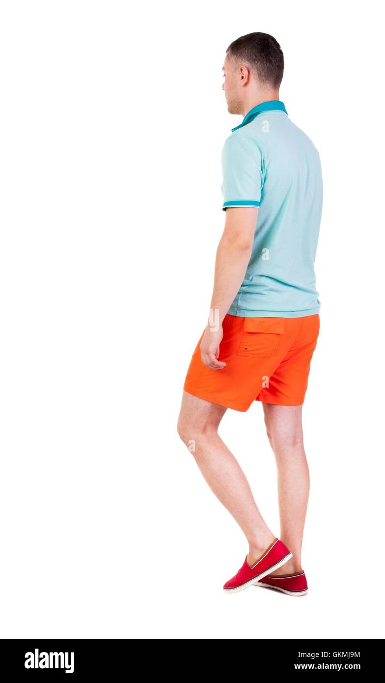 Back view of going handsome man in shorts. walking young guy . Rear ...