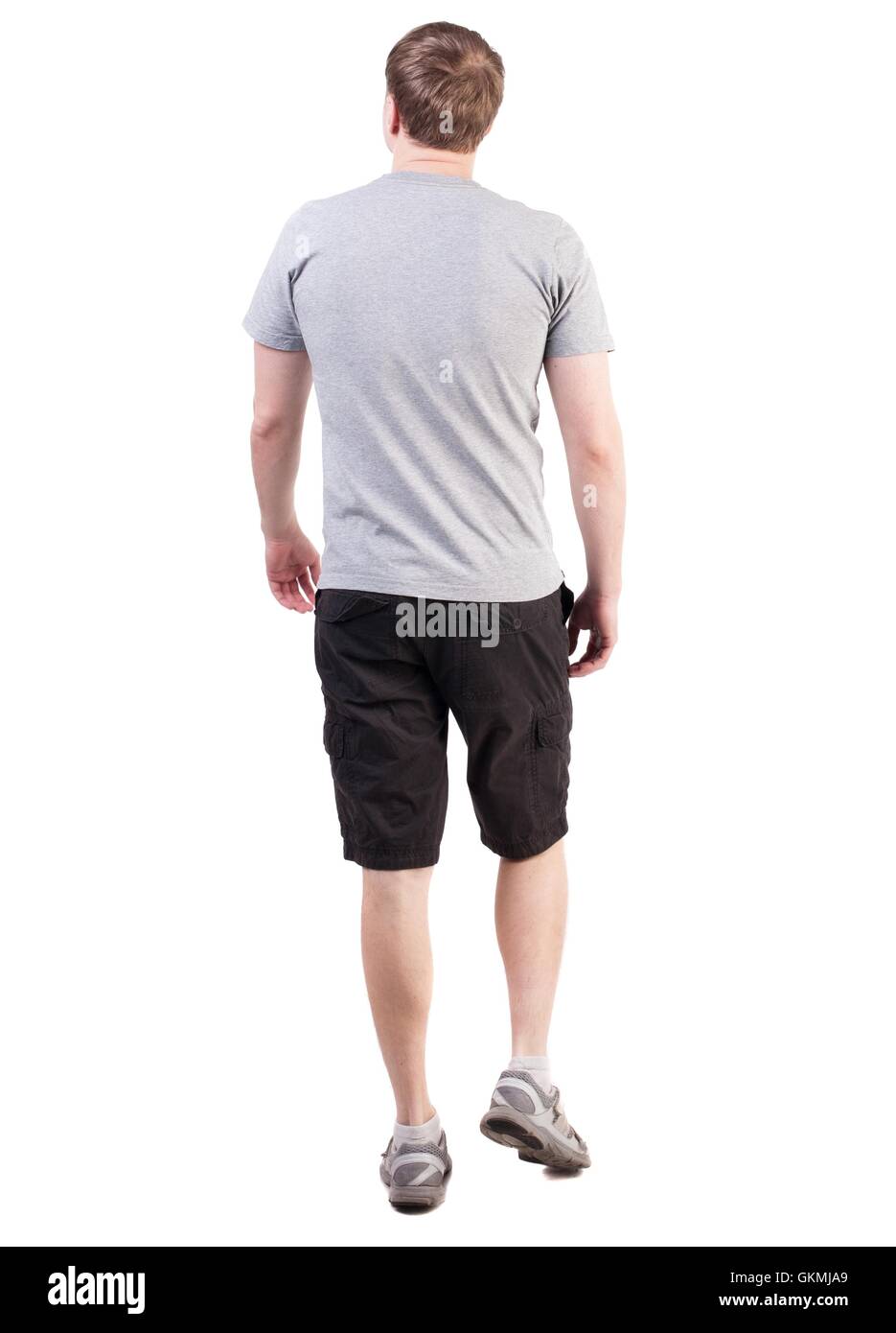 Back view of walking handsome man in shorts and sneakers Stock Photo ...