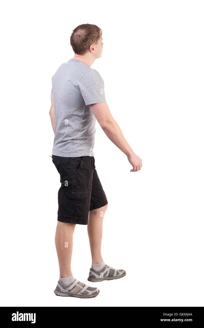 Back view of walking handsome man in shorts and sneakers. Sports ...
