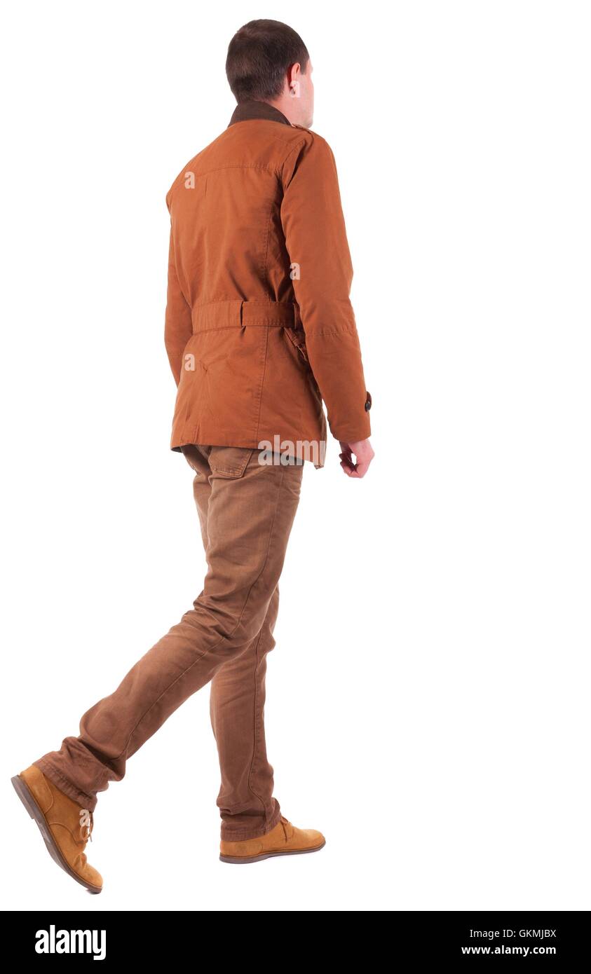 Back view of going stylishly dressed man in a brown jacket. walking ...
