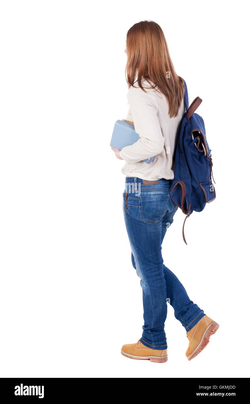 Girl with a backpack on his back is a stack of books. back view. Rear ...
