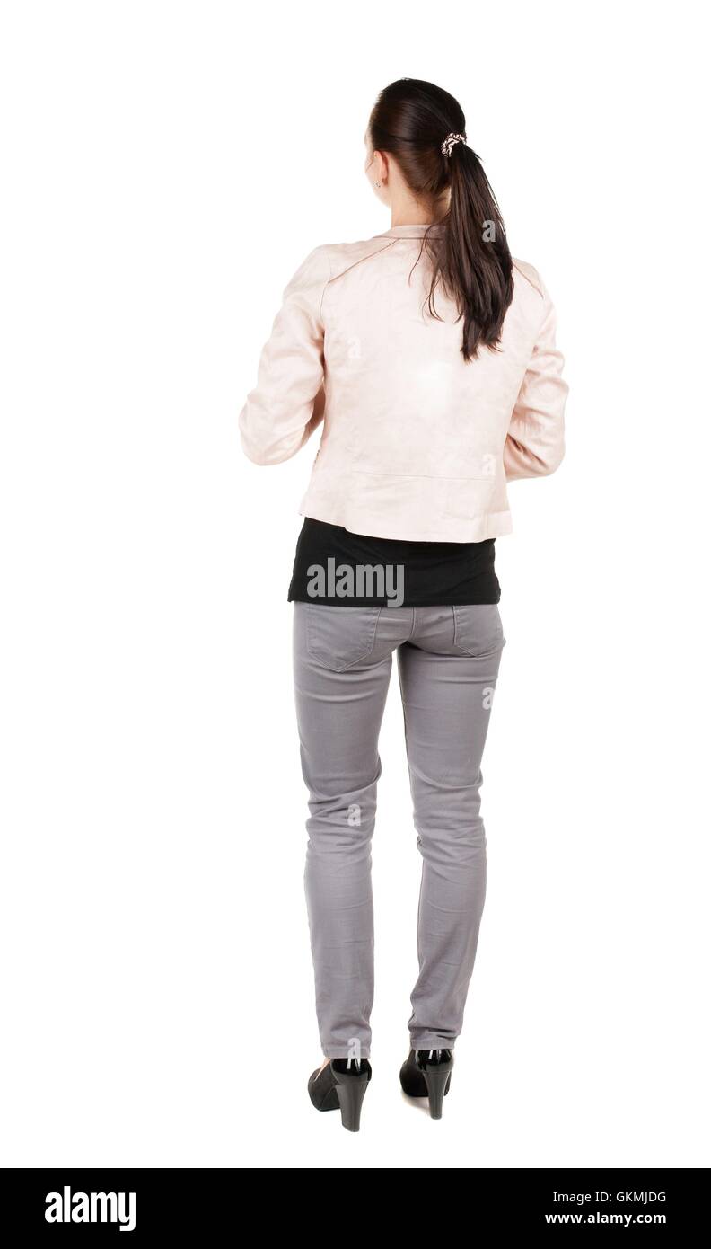 back view of standing young beautiful brunette woman. girl watching ...