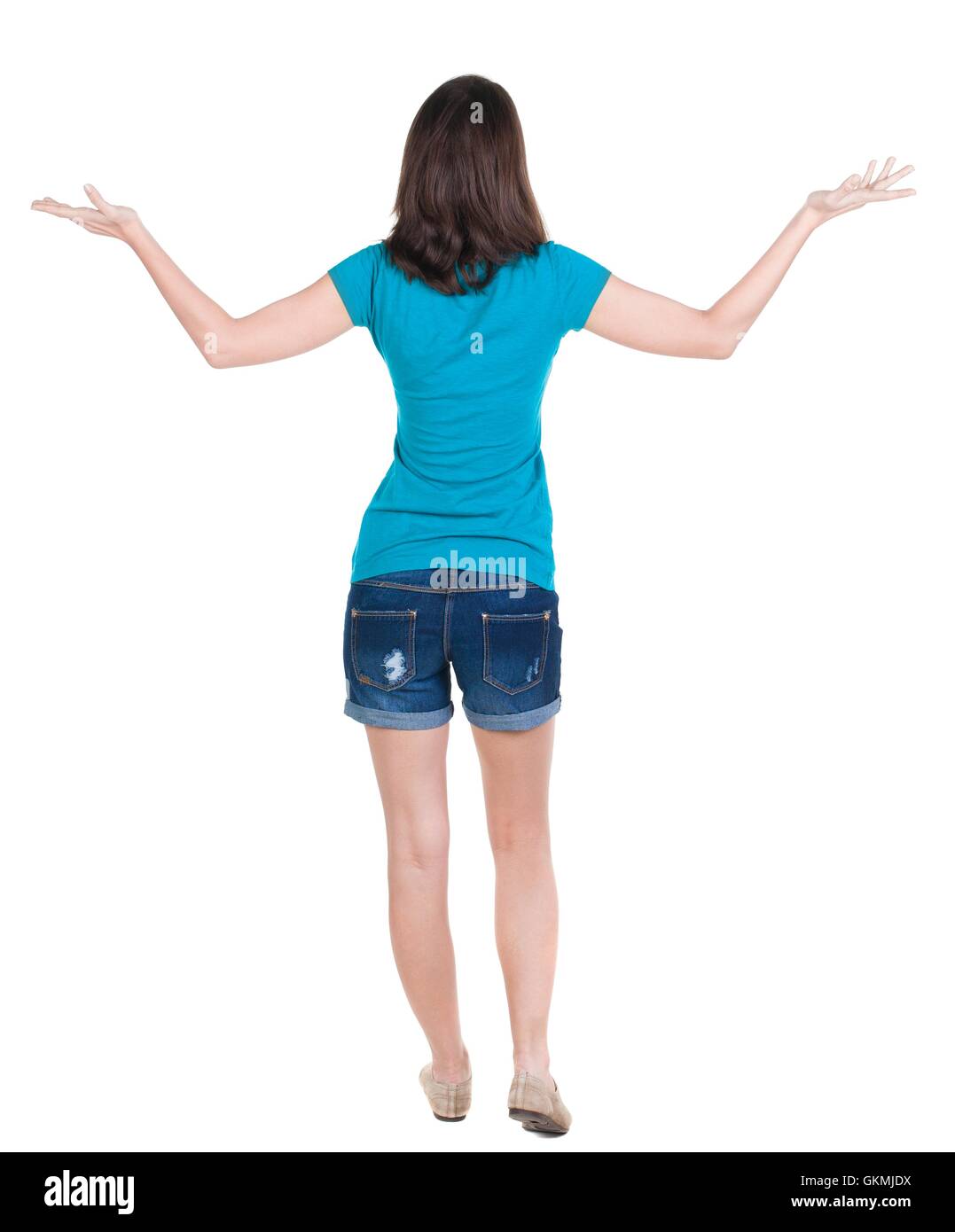 Back view of Beautiful woman in in sandals holds hand up. Rear view ...