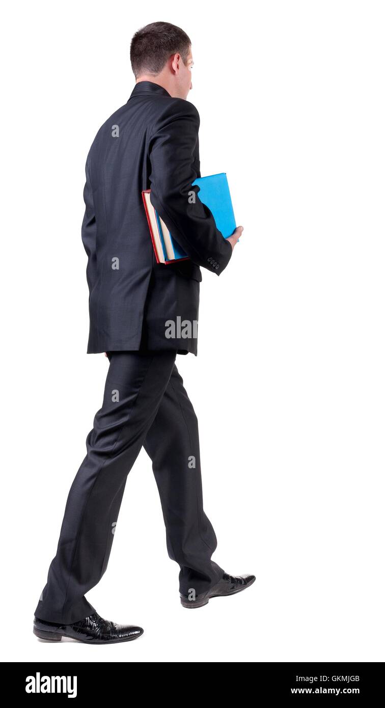 back view of walking business man with books. going young guy in black ...