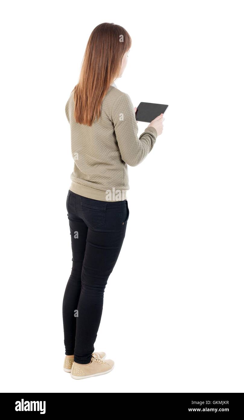 back view of standing young beautiful girl with tablet computer in the ...