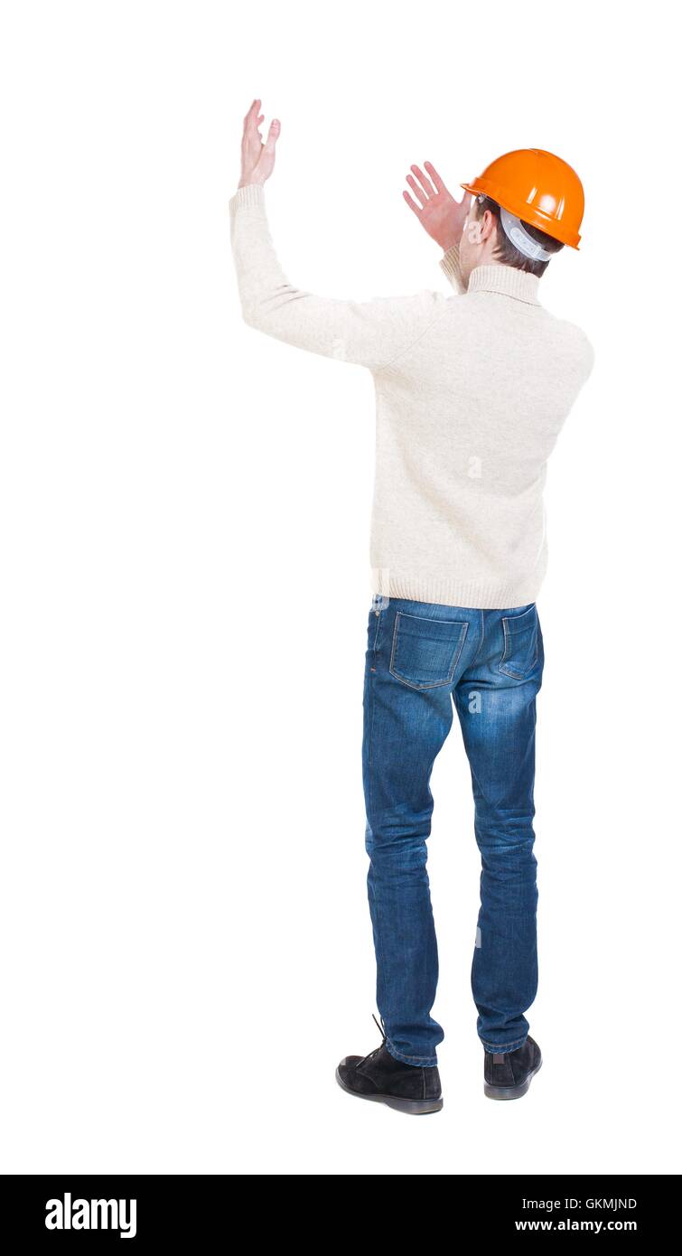 Back view of pointing young men in helmet. Young guy gesture. Rear view ...