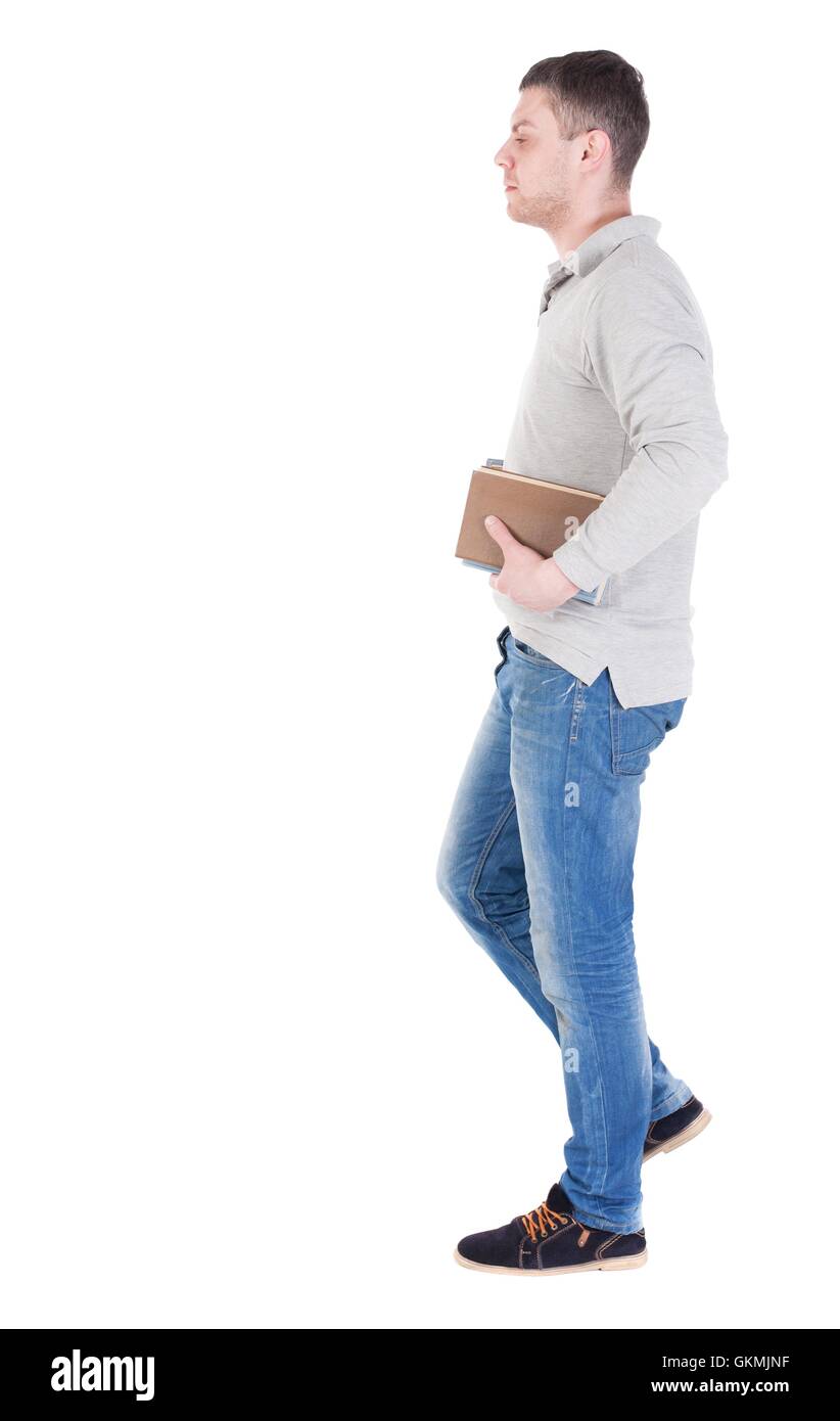 man goes and has a stack of books. back view. Rear view people ...