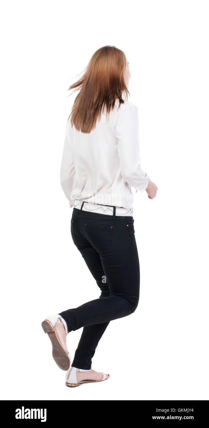 back view of running woman in white shirt. beautiful blonde girl in ...