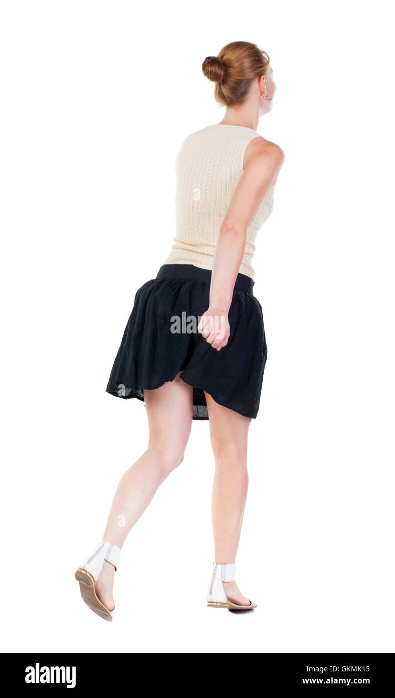 back view of running woman in dress. beautiful blonde girl in motion ...