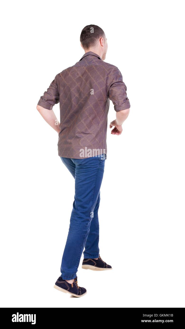 Back view of running man in brown shirt. Walking guy in motion. Rear ...