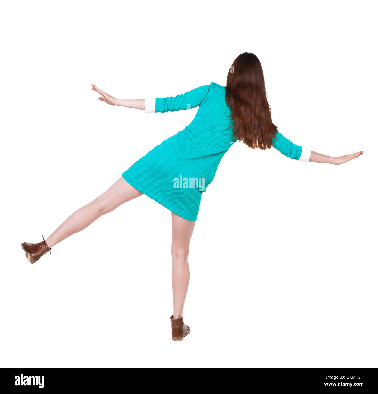 Back view woman Balances waving his arms. Standing young girl in dress ...