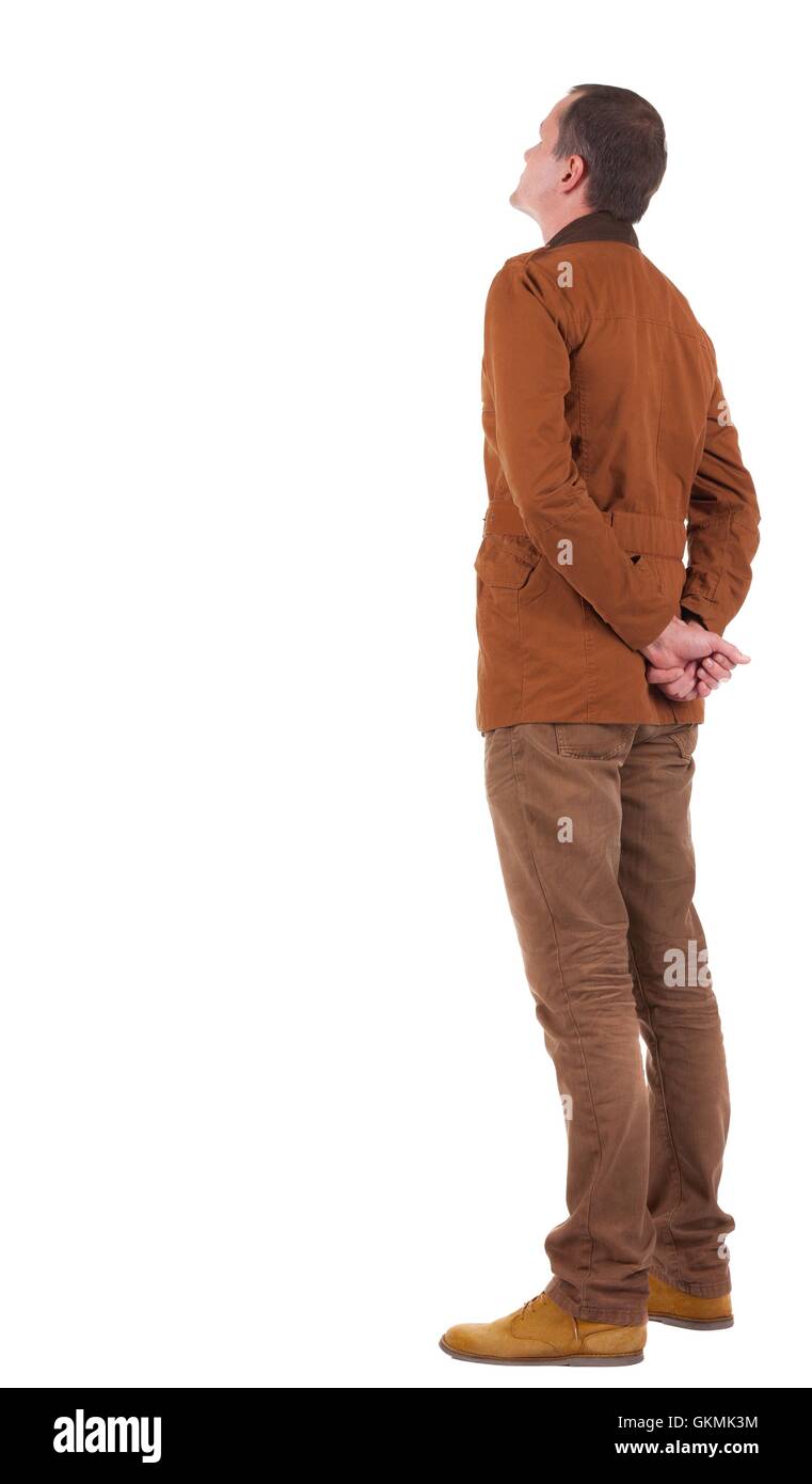 Back view of stylishly dressed man in a brown jackett looking up ...