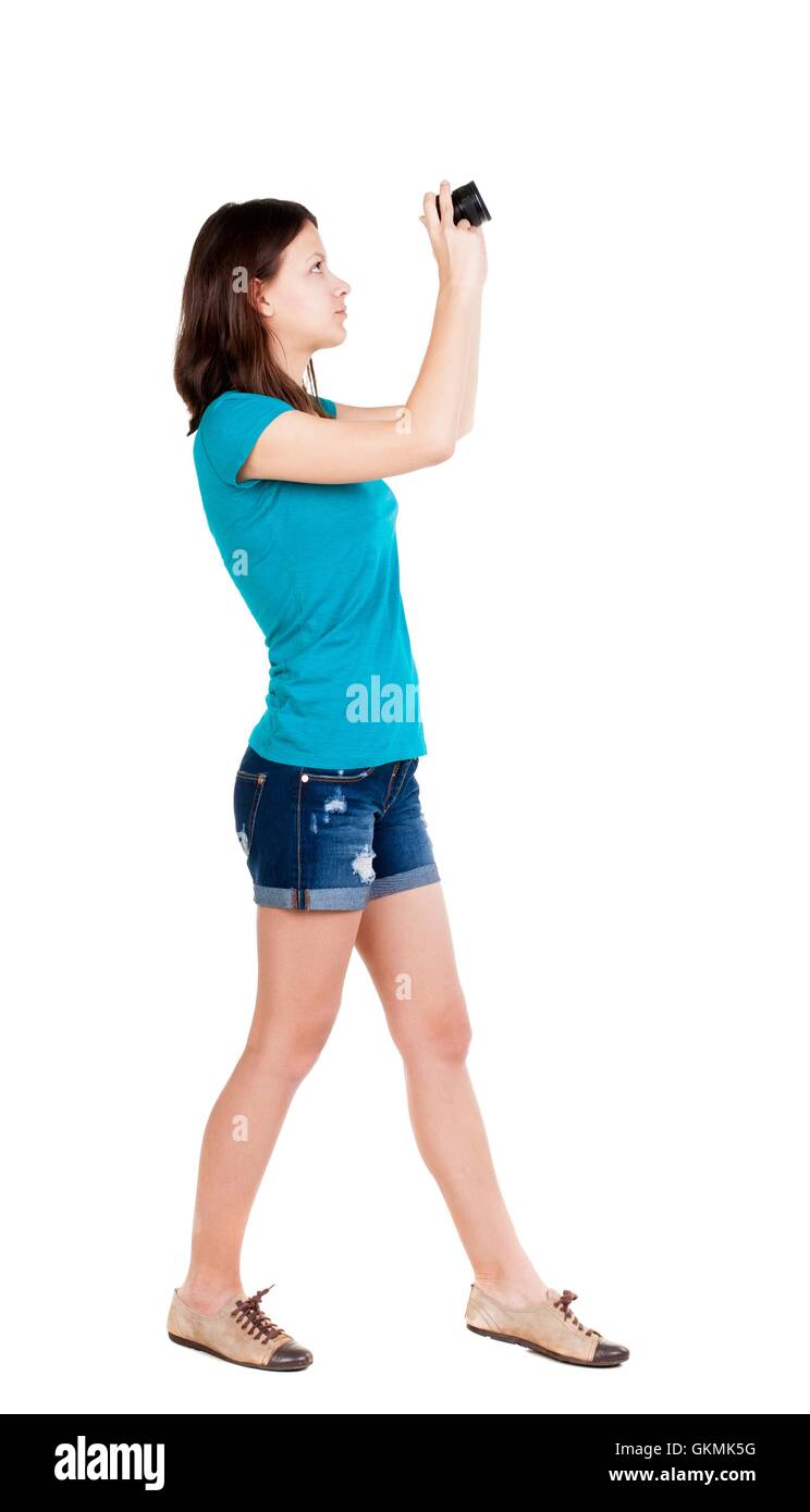 young woman in shorts photographed something compact camera. Isolated ...