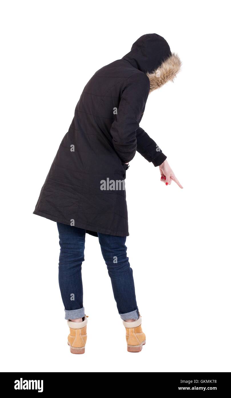 Back view of pointing young women in parka. Young girl gesture. Rear ...