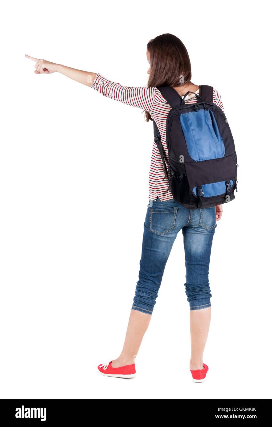 Back view of pointing woman with backpack looking up. Standing young ...