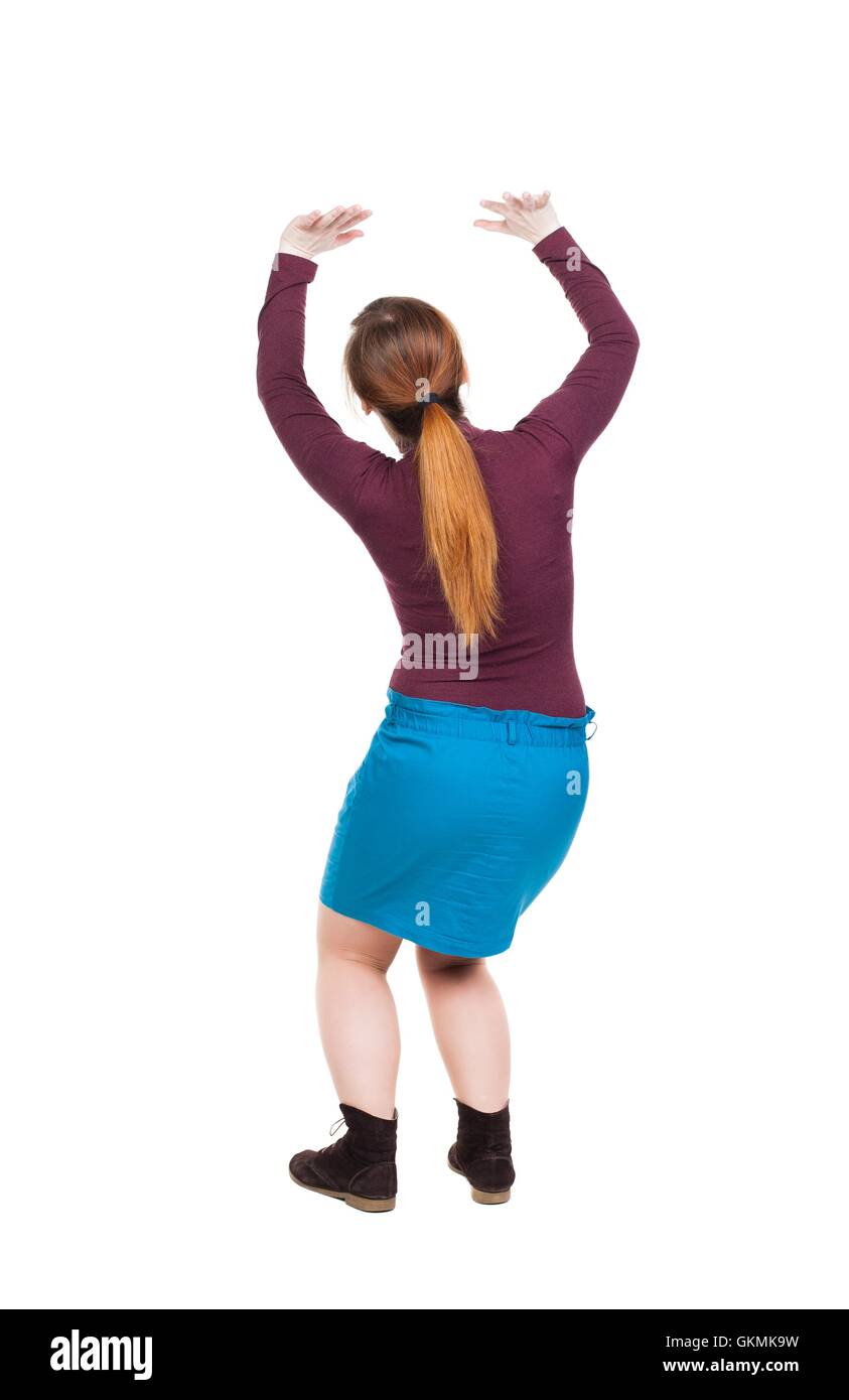 back view of woman protects hands from what is falling from above. Man ...