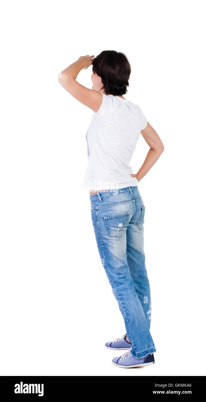 back view of standing young beautiful brunette woman. girl watching ...