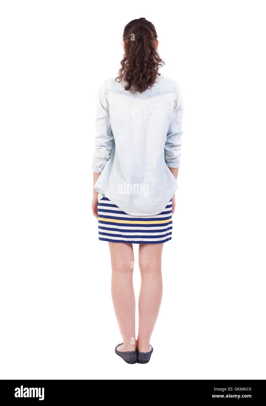 back view of standing young beautiful woman. girl watching. Rear view ...