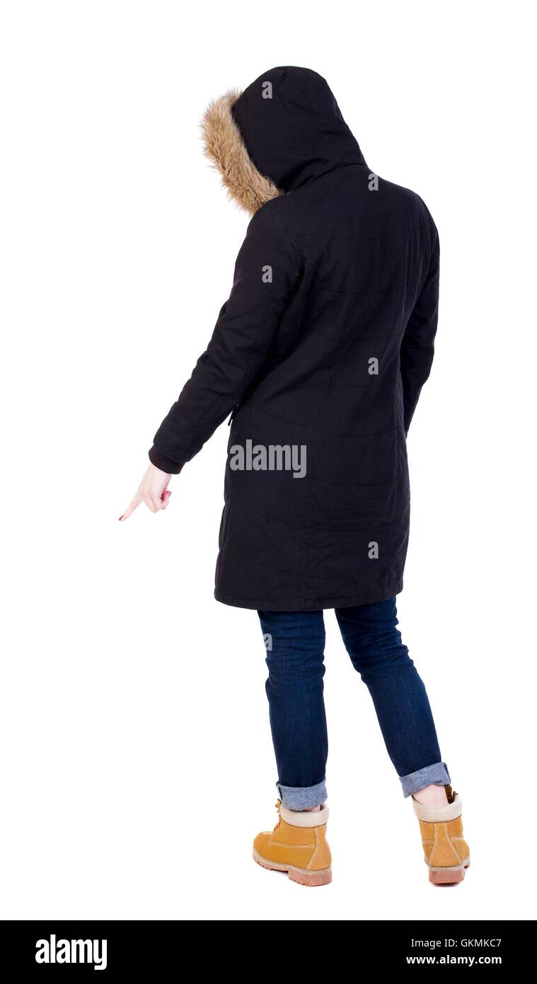 Back view of pointing young women in parka. Young girl gesture. Rear ...