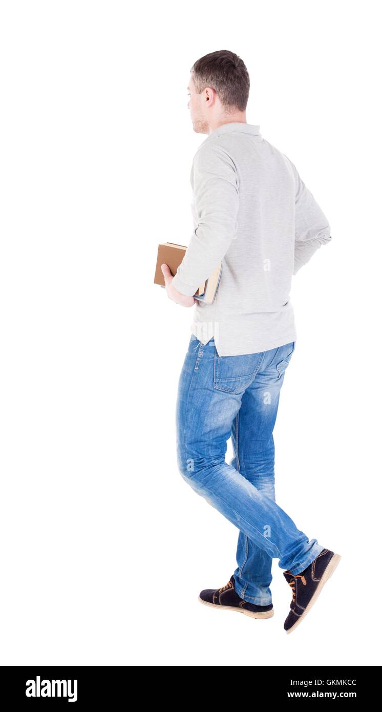 man goes and has a stack of books. back view. Rear view people ...