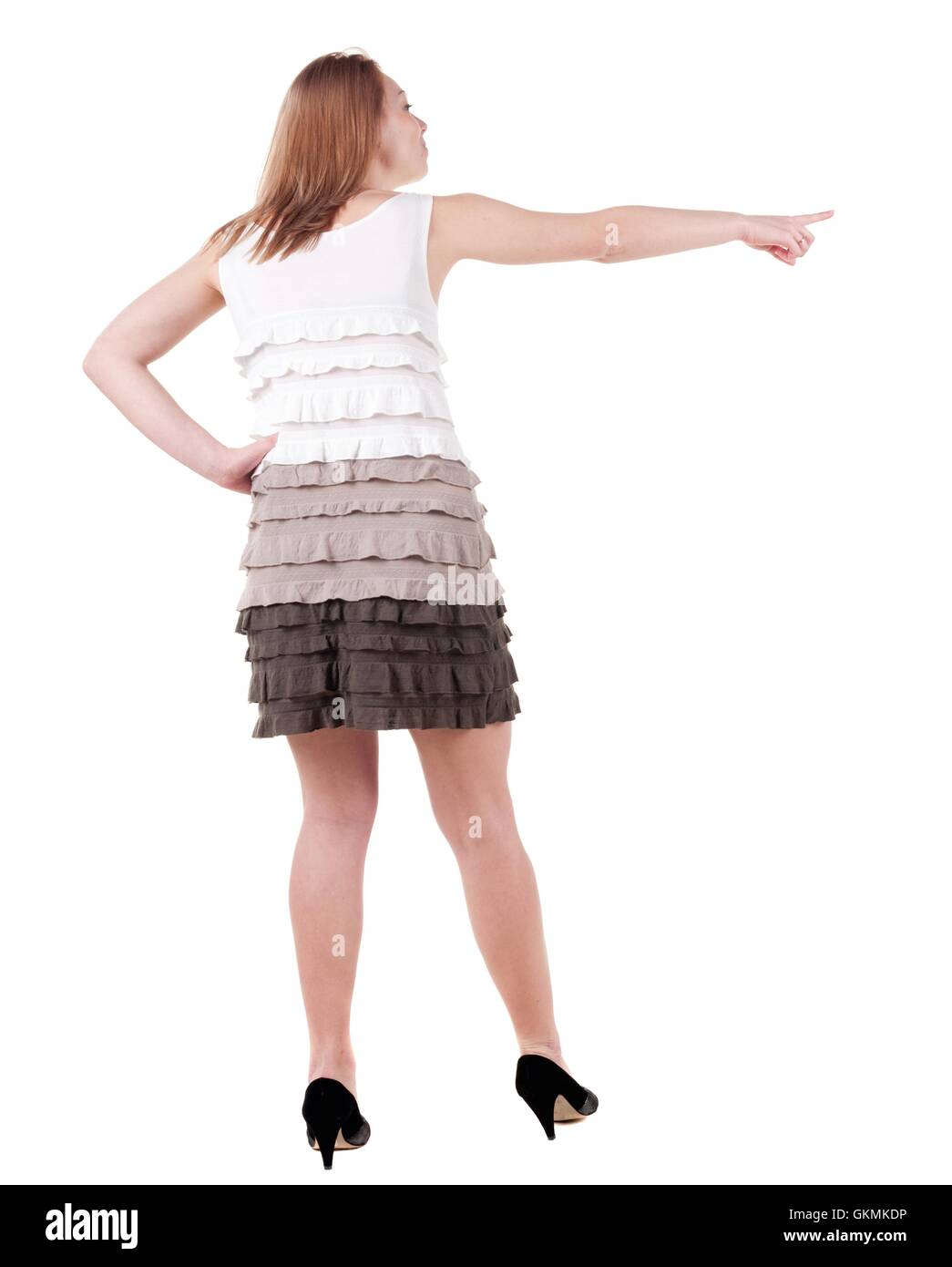 Back view of young blonde woman pointing .beautiful girl in dress ...