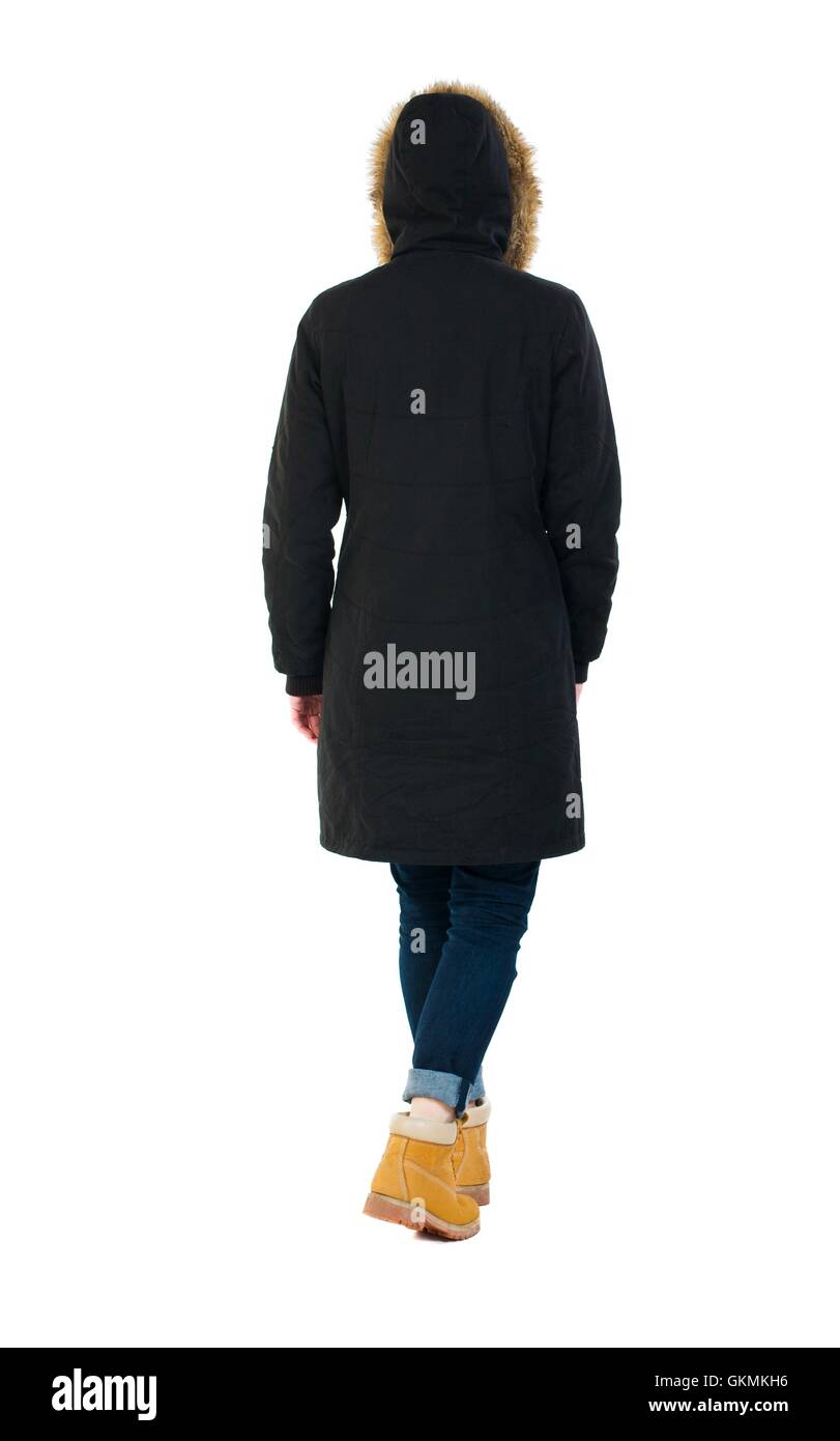 Back view of going woman in parka. walking young girl. Rear view people ...