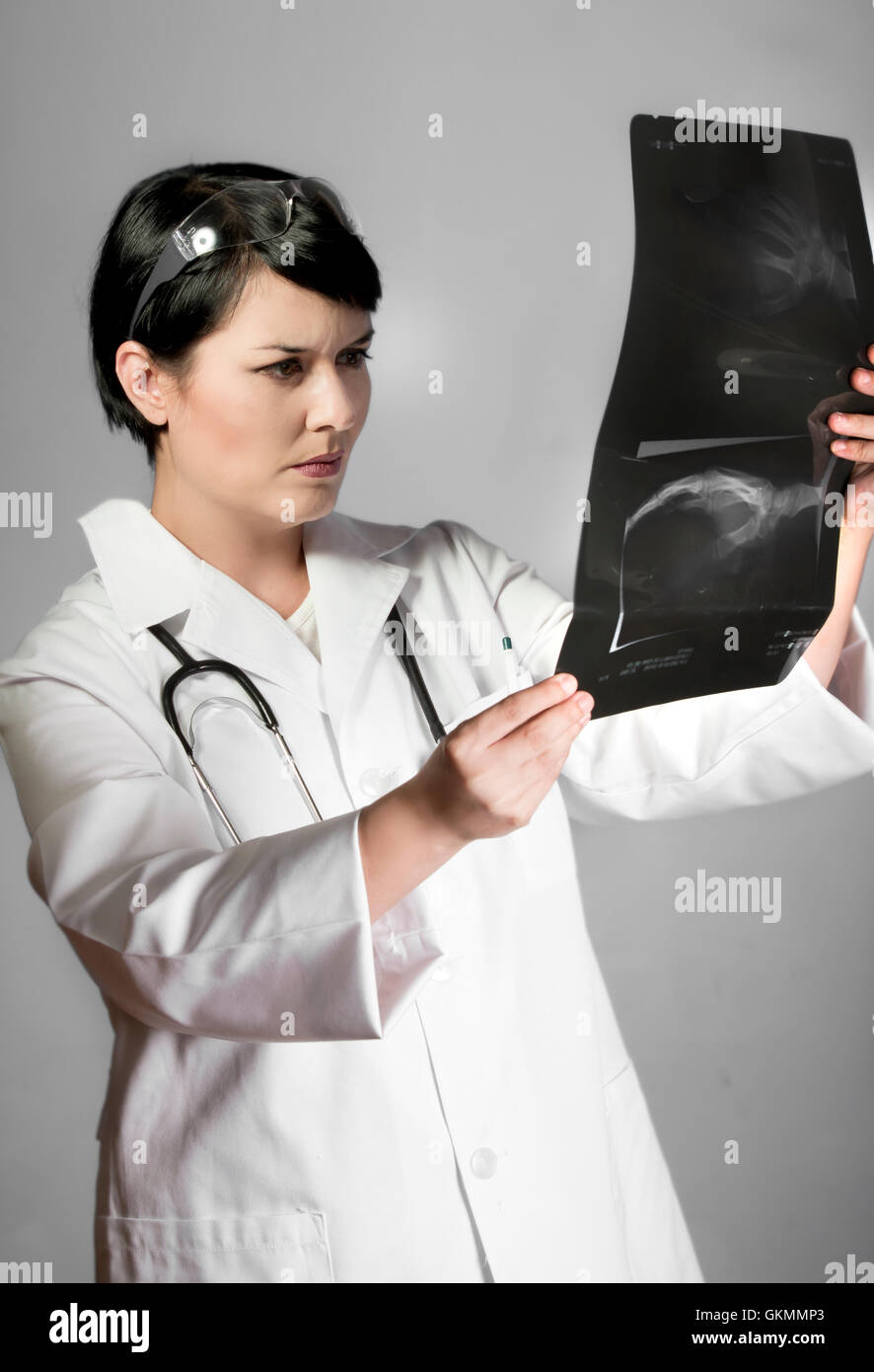 brunette female doctor checking X-Rays Stock Photo - Alamy