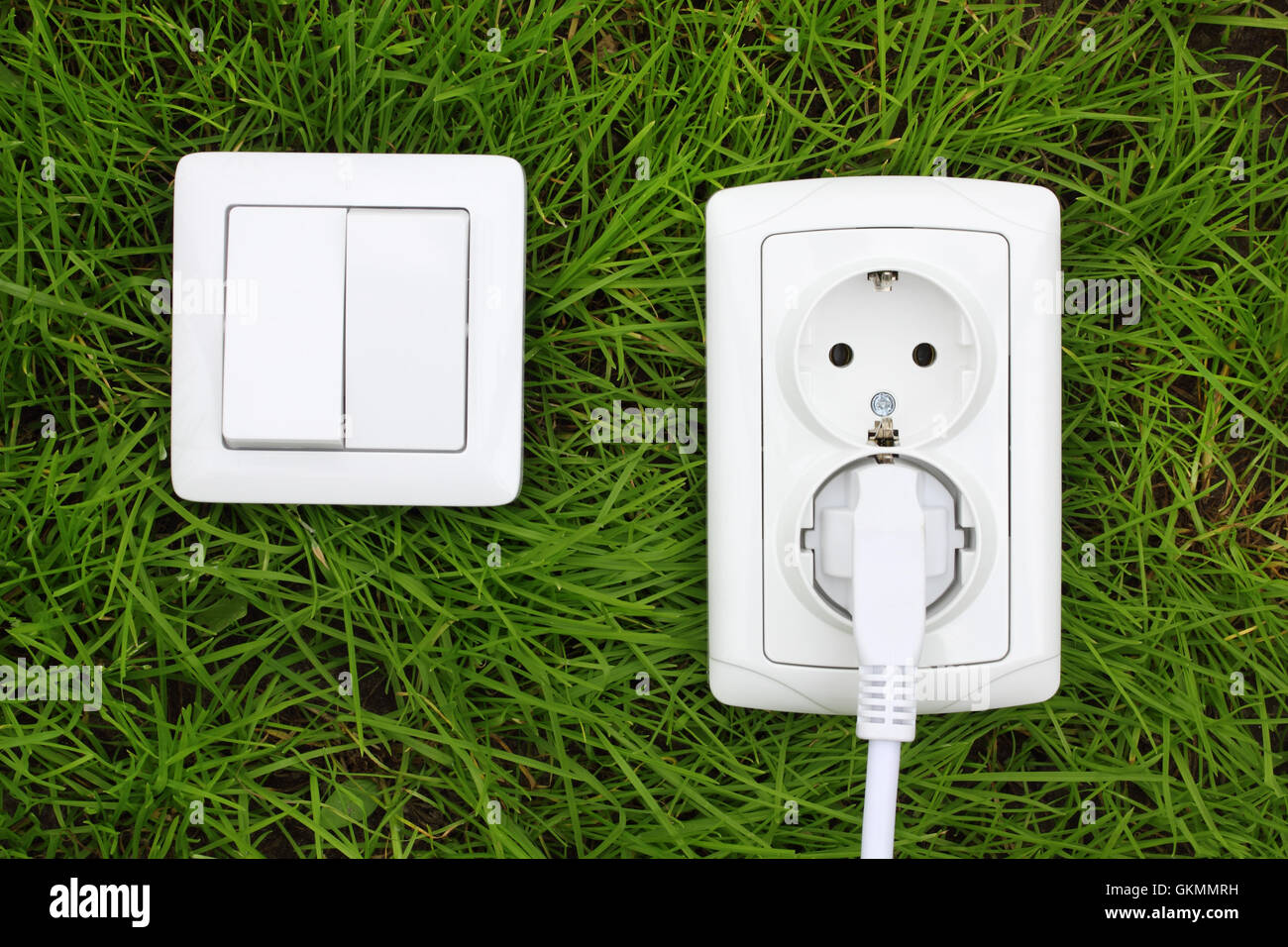 power receptacle and light switch on a green grass Stock Photo - Alamy