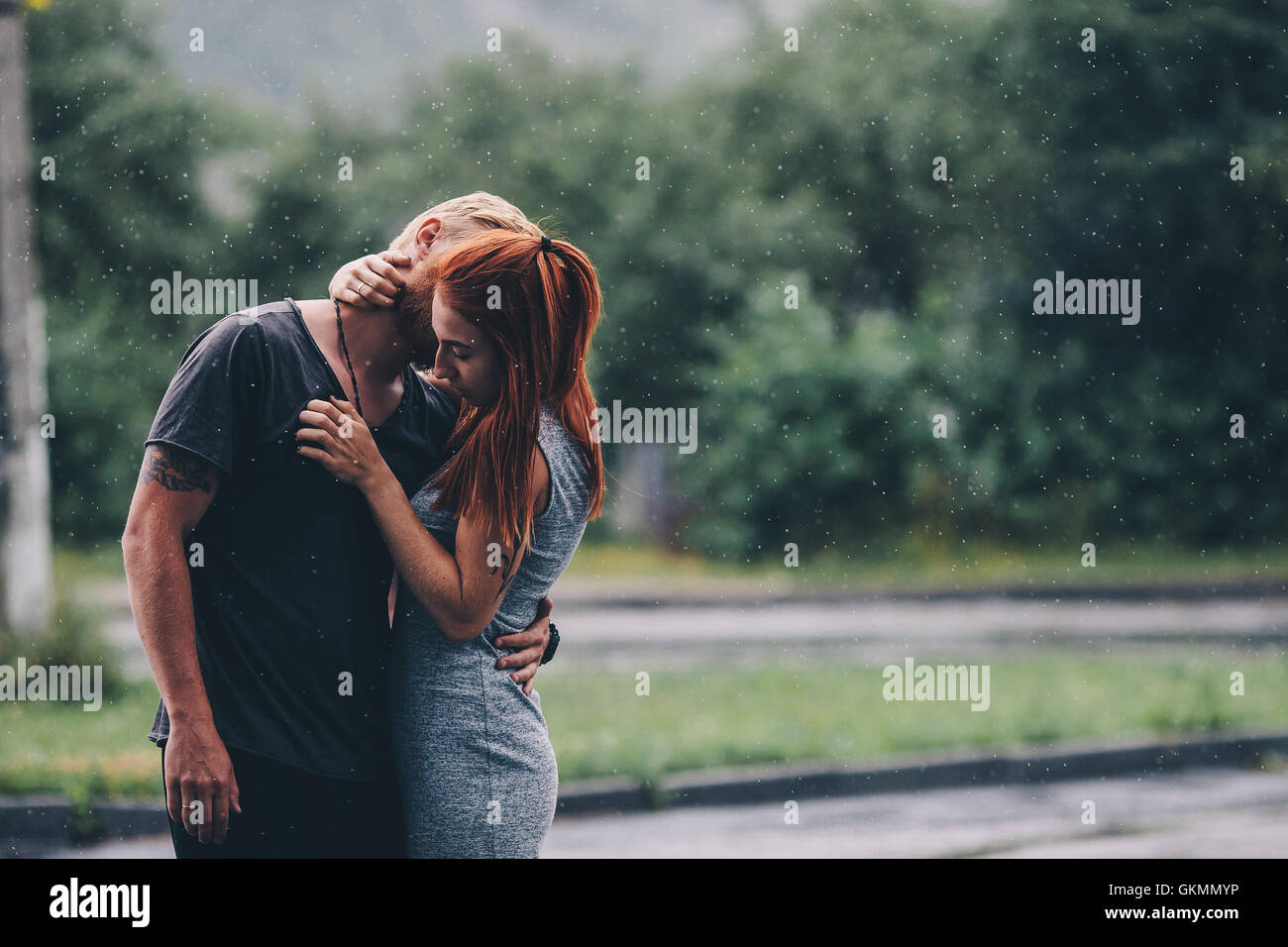 beautiful couple hugging in the rain Stock Photo - Alamy