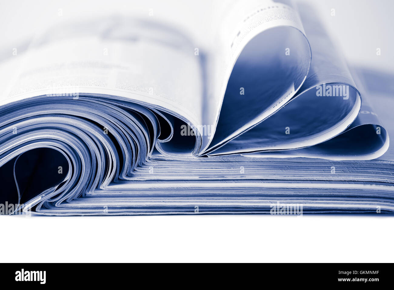 stack of magazines toned blue isolated Stock Photo - Alamy