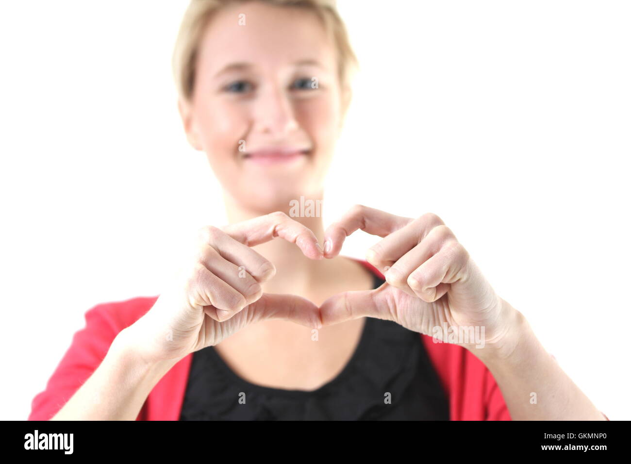 woman making a finger heart sign Stock Photo - Alamy