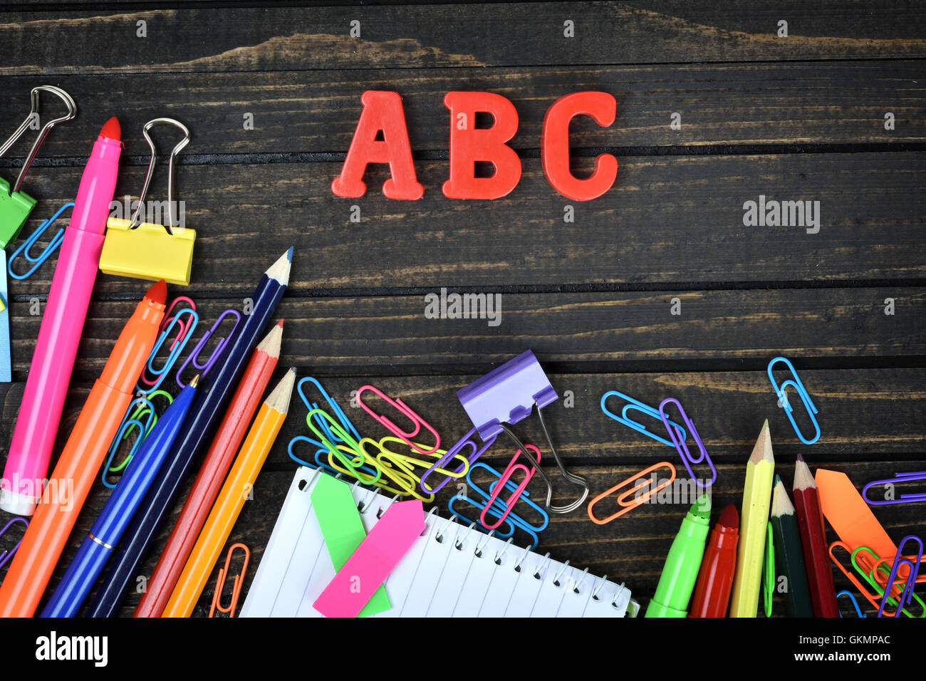 ABC and office tools on wooden table Stock Photo - Alamy